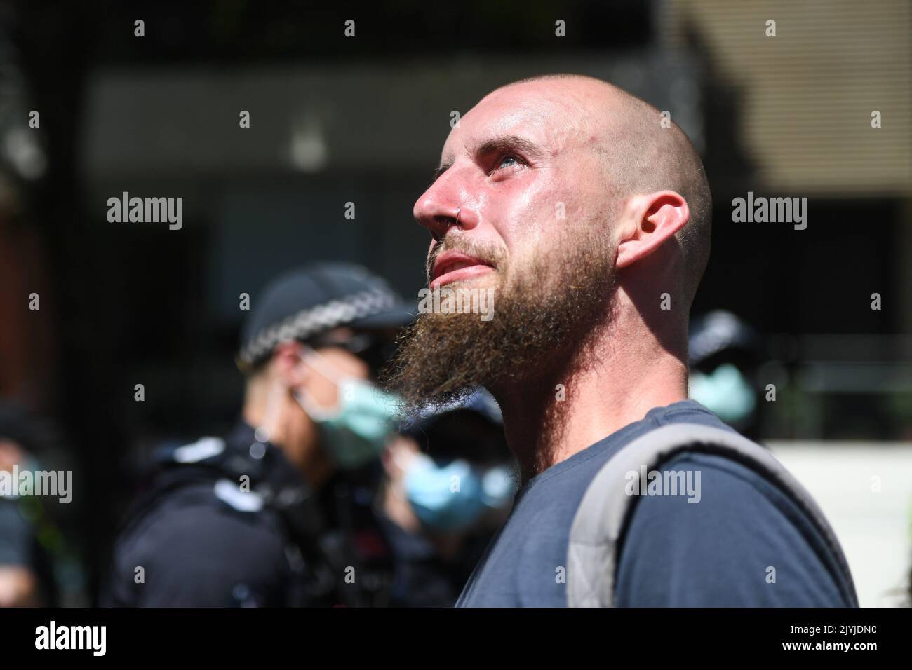 A protester reacts outside the the Park Hotel in Melbourne, Saturday ...