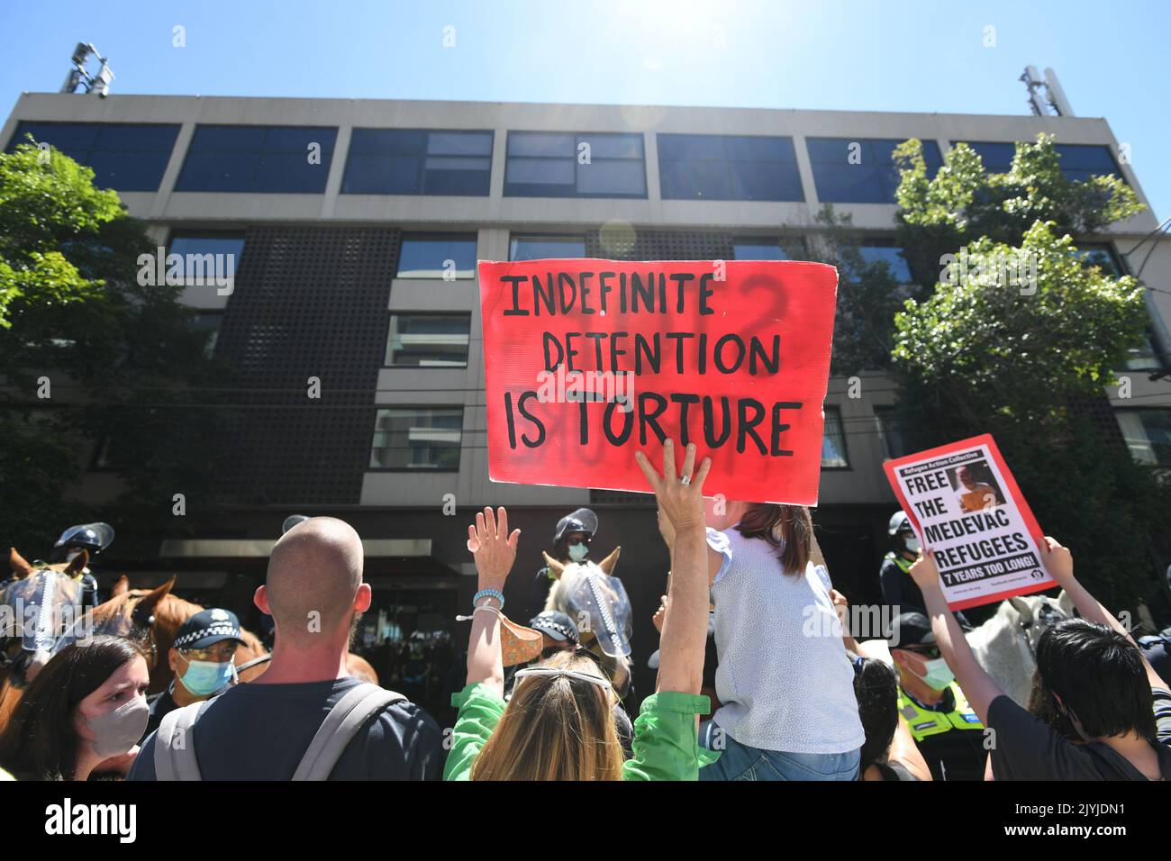 Protesters are seen outside the the Park Hotel in Melbourne, Saturday ...