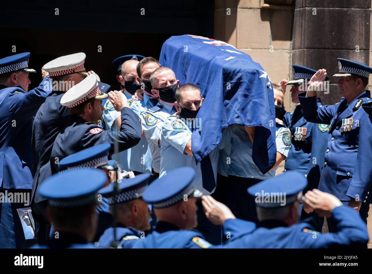 Members of the NSW Police stand in a guard of honour as the casket of ...