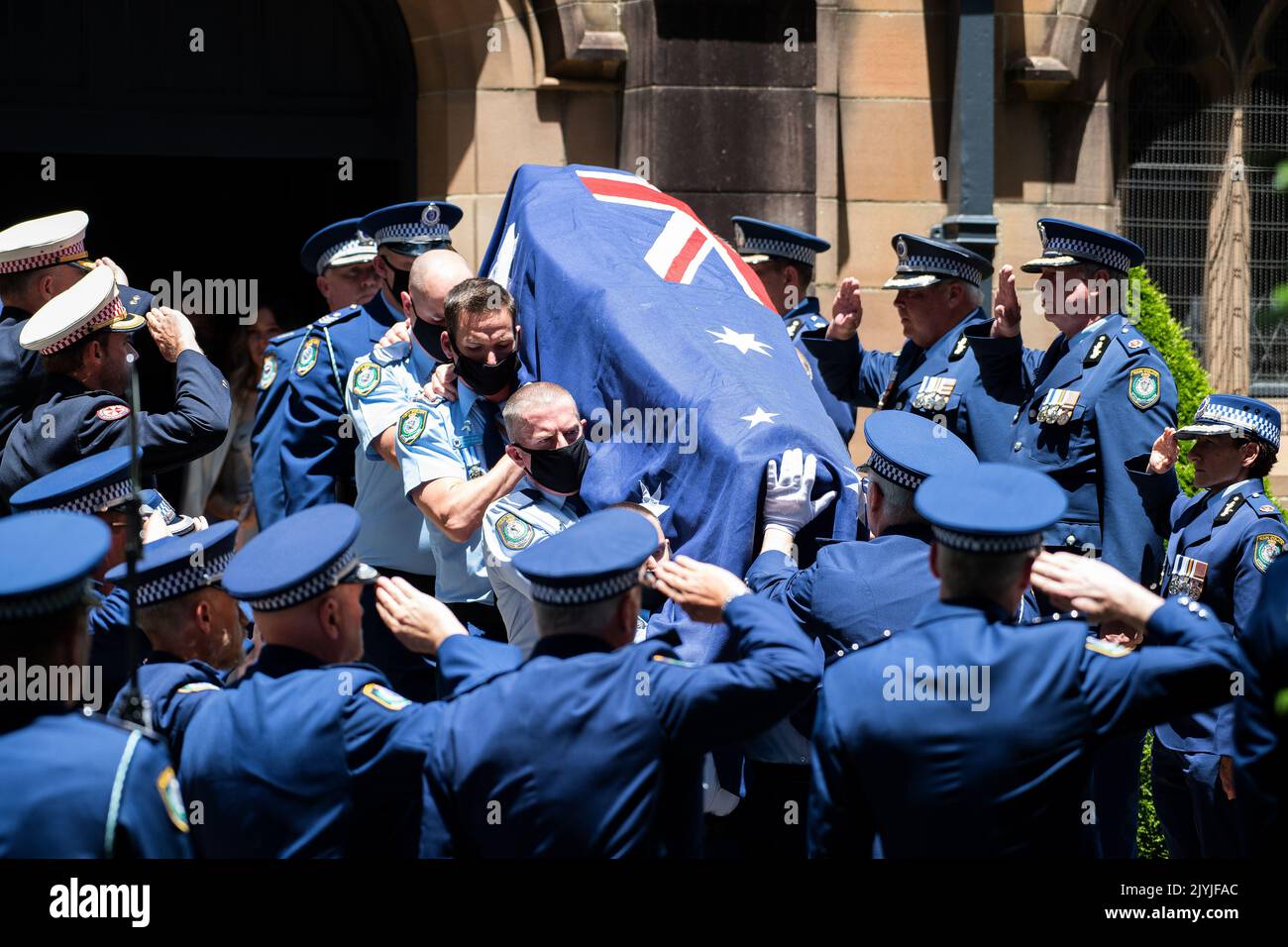 Members of the NSW Police stand in a guard of honour as the casket of ...