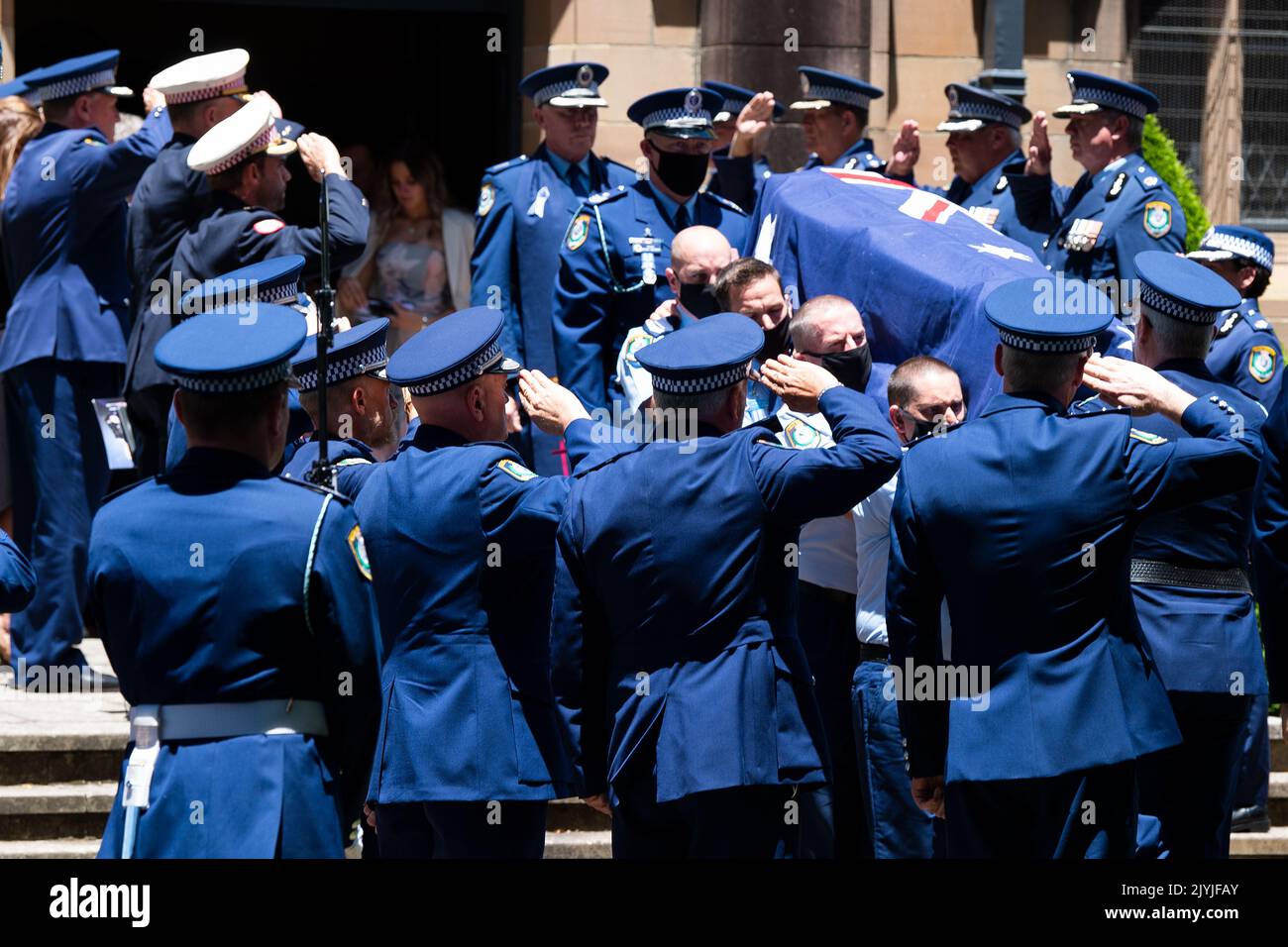 Members of the NSW Police stand in a guard of honour as the casket of ...