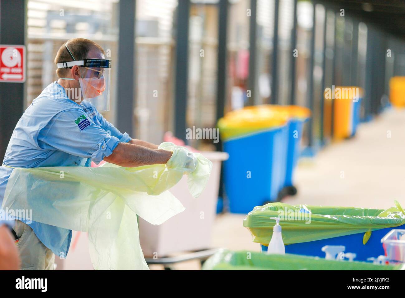 AUSMAT staff at a PPE Doffing Station , disposing of "Dirty" PPE at the ...