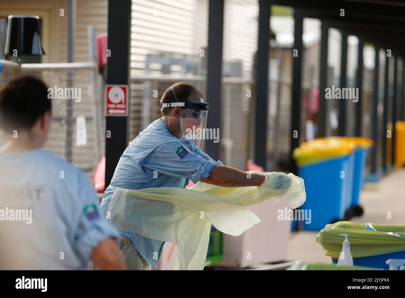 AUSMAT staff at a PPE Doffing Station , disposing of "Dirty" PPE at the ...