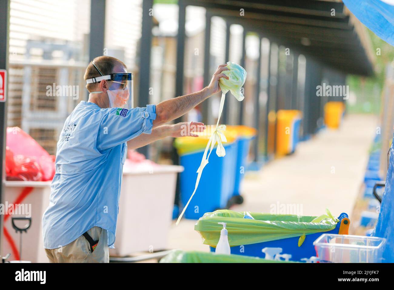AUSMAT staff at a PPE Doffing Station , disposing of "Dirty" PPE at the ...