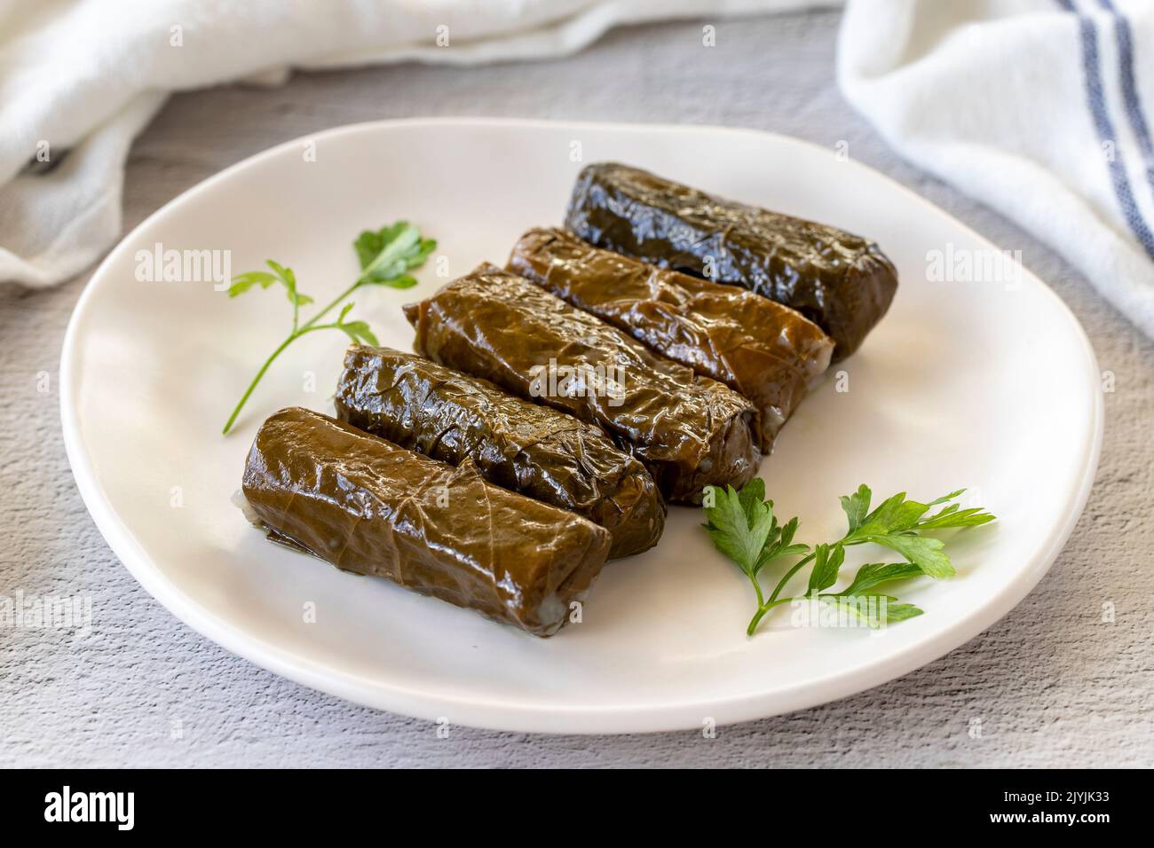 Stuffed leaves with olive oil on a stone background. Traditional ...
