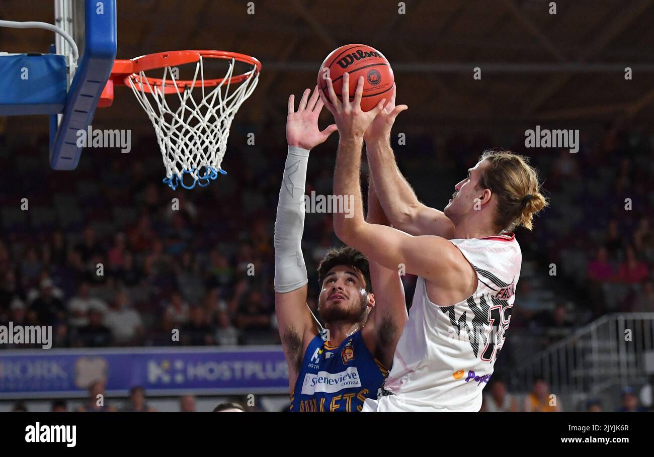 Sam Froling (right) of the Hawks shoots over Tyrell Harrison (left) of ...