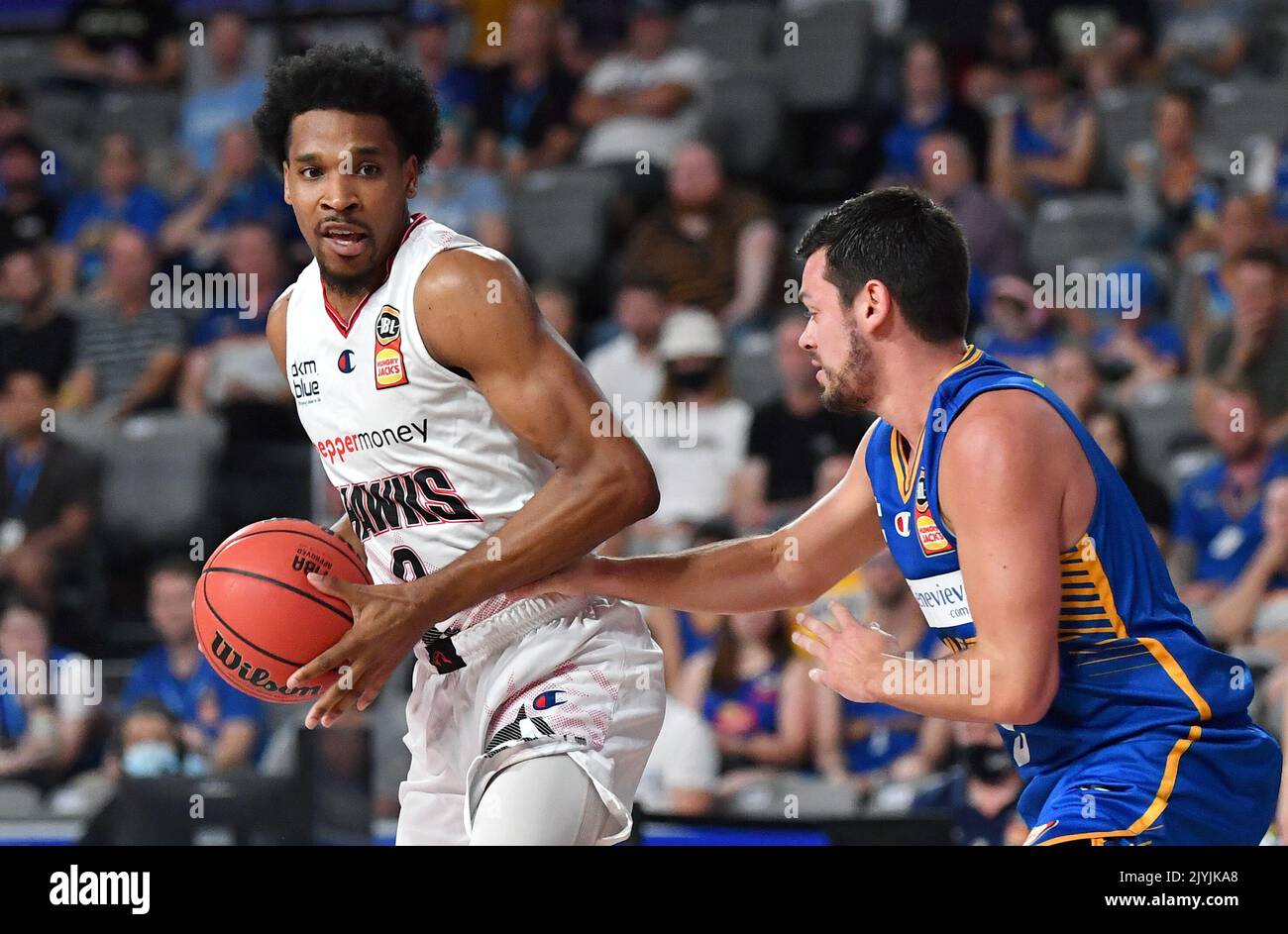 Justin Simon (left) of the Hawks takes on Jason Cadee (right) of the ...