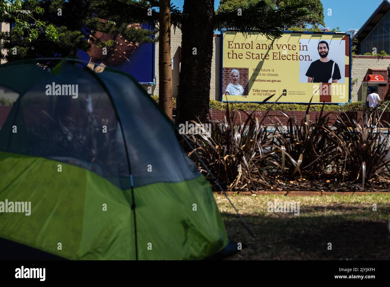 An election poster encouraging people to enroll to vote is seen behind ...