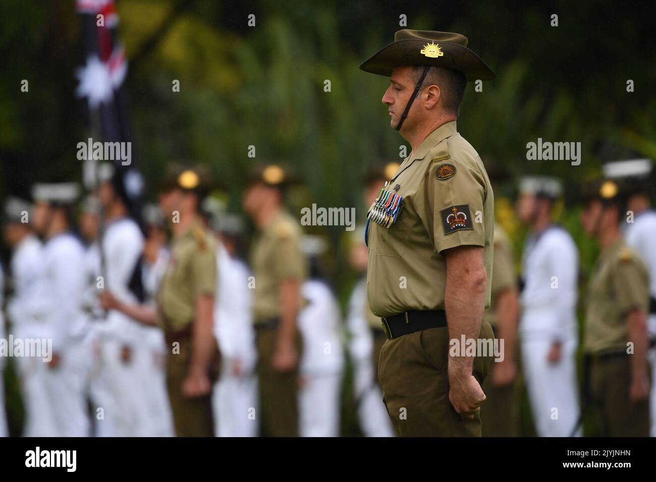 Military guard are seen during a flag raising ceremony on Australia Day ...