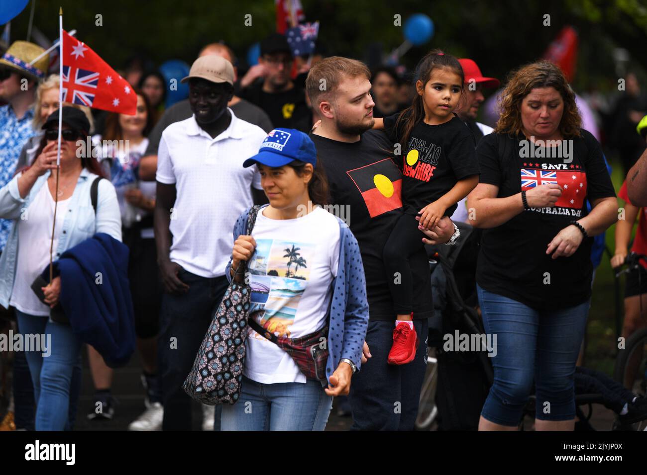 First nation Australian's (centre) are seen waiting at an intersection ...
