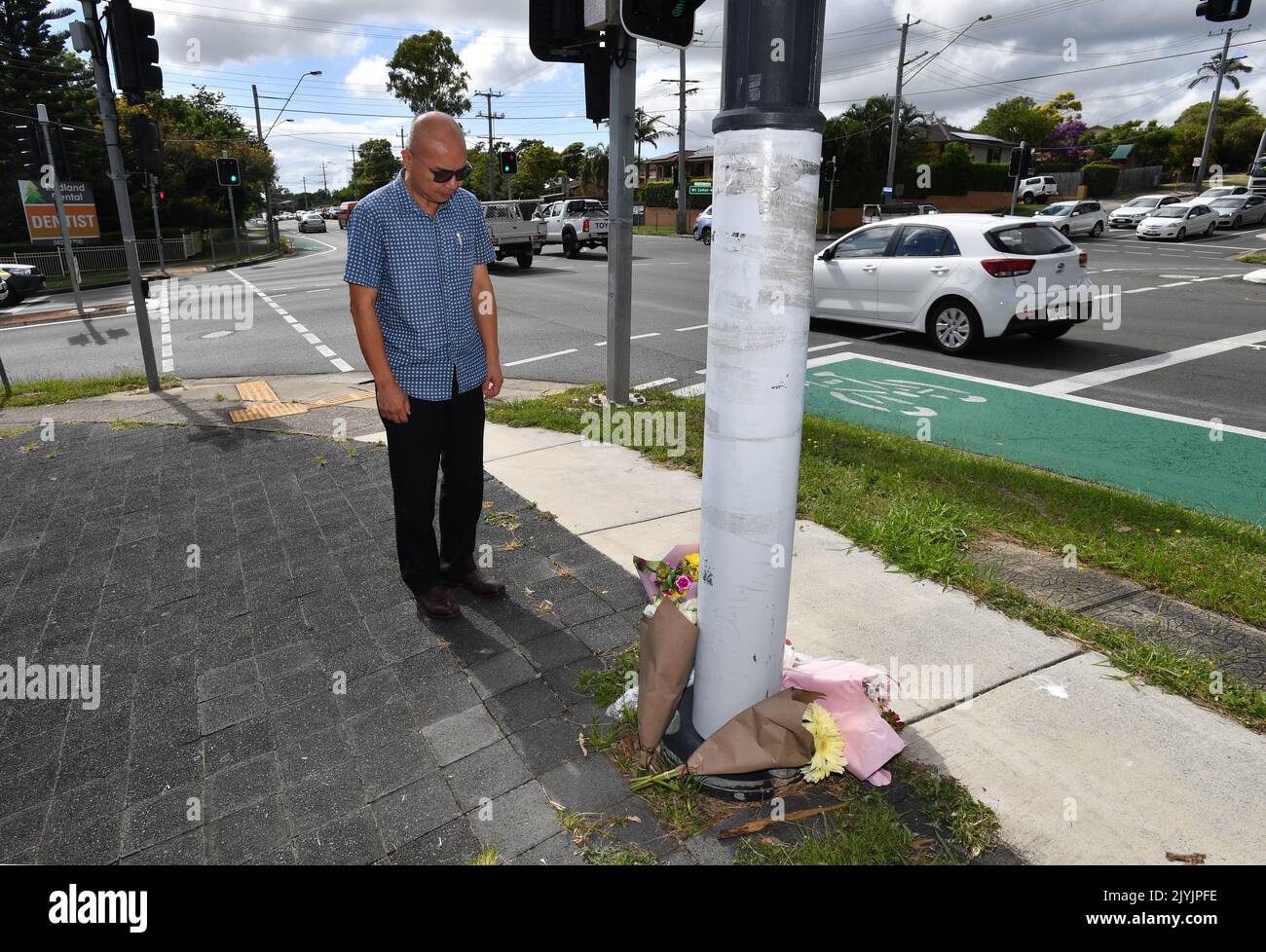 Former Capalaba MP Michael Choi is seen laying flowers at the scene ...
