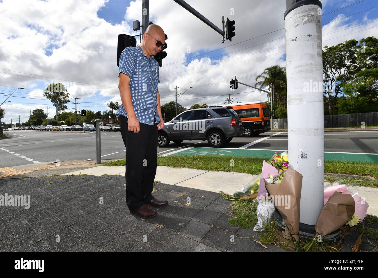 Former Capalaba MP Michael Choi is seen laying flowers at the scene ...