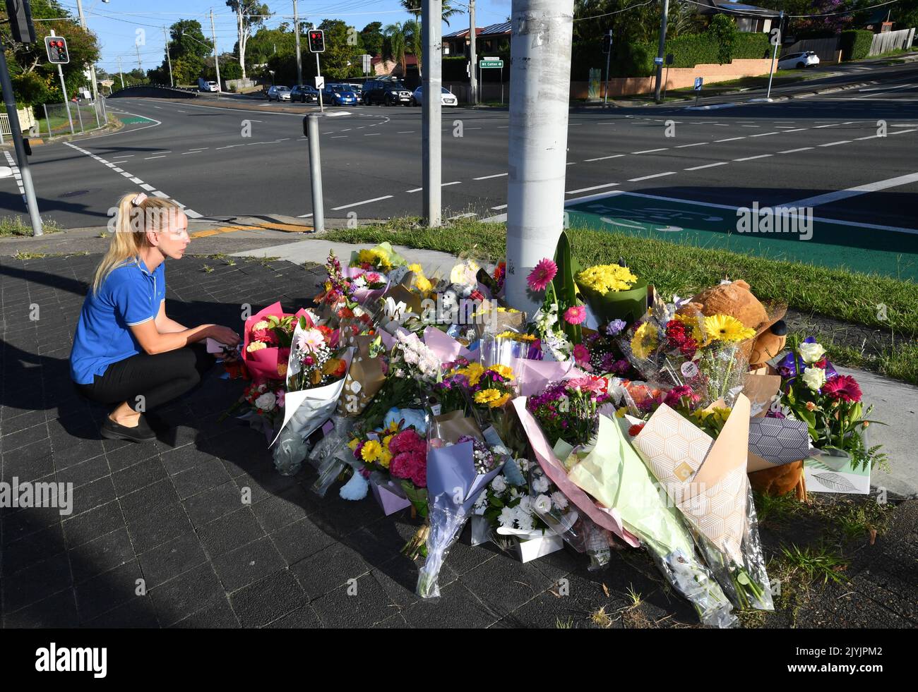 A women is seen laying flowers at the scene where two pedestrians ...