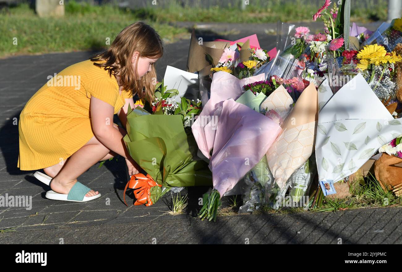 A child is seen laying flowers at the scene where two pedestrians, Kate ...