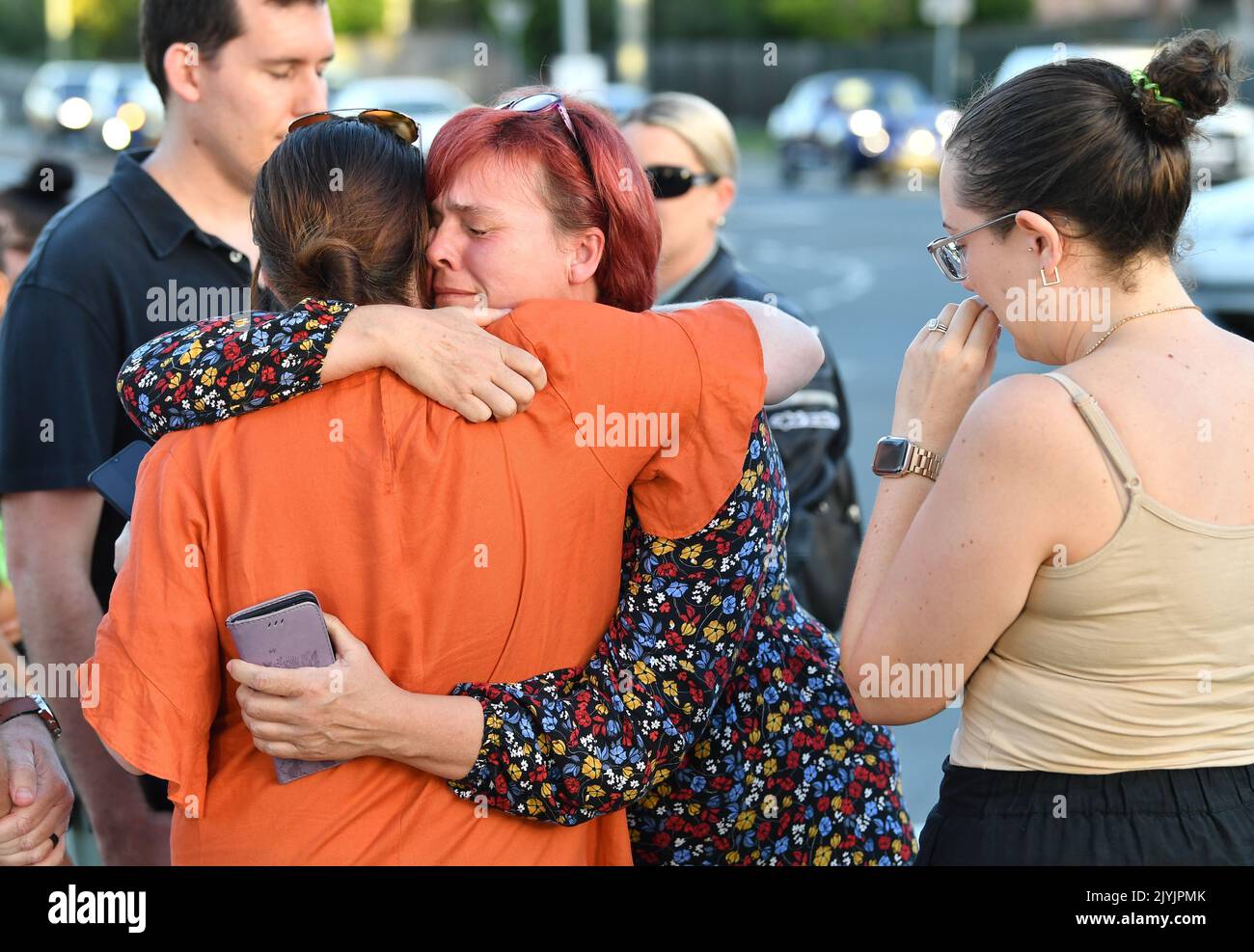People are seen consoling each other at a vigil for Kate Leadbetter, 31 ...