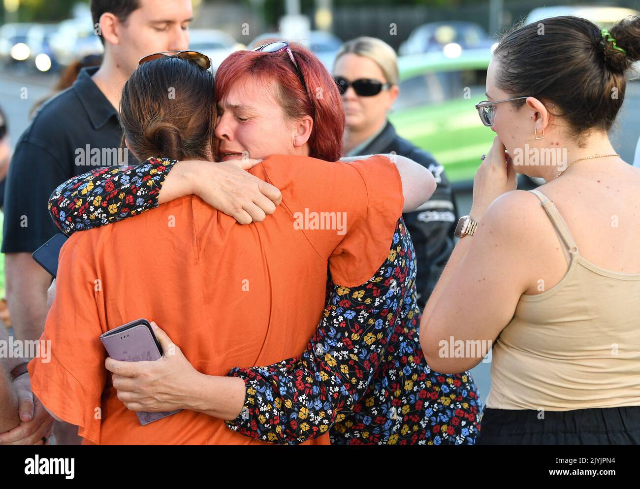 People are seen consoling each other at a vigil for Kate Leadbetter, 31 ...