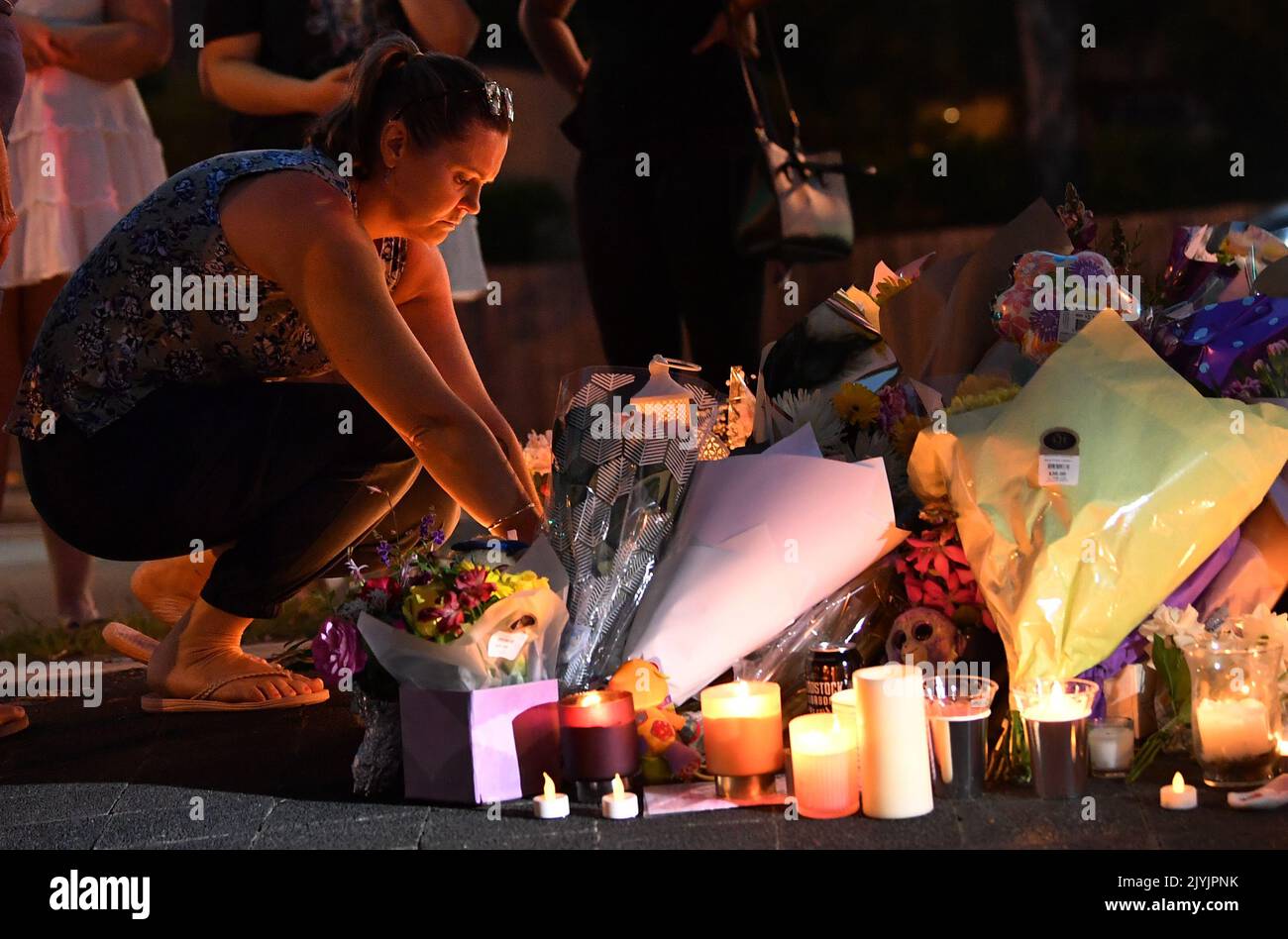 A women is seen laying flowers at a vigil for Kate Leadbetter, 31, and ...