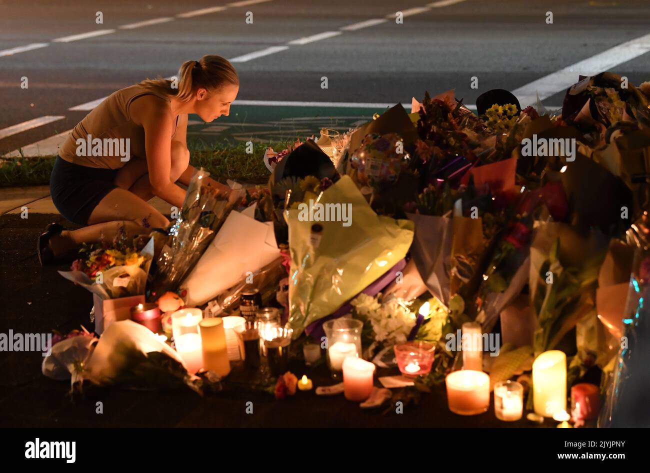 A women is seen laying flowers at a vigil for Kate Leadbetter, 31, and ...