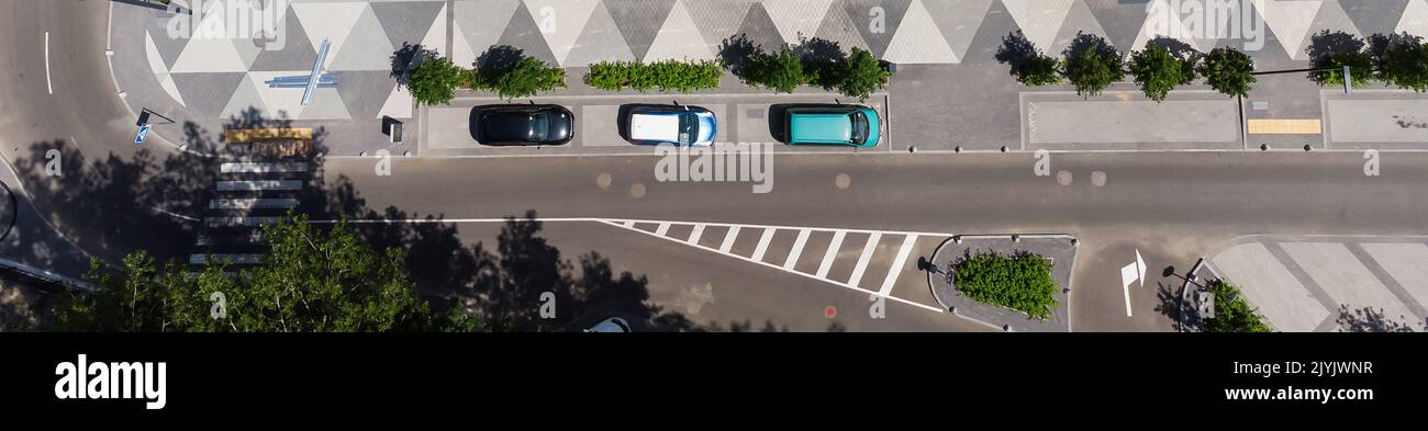 aerial top view of street with parking lot near new residential housing ...