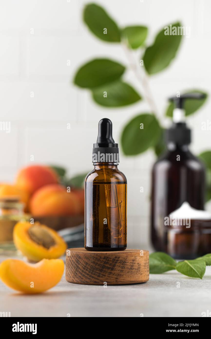 Oil with peach kernel extract in a brown glass pipette. Natural ...