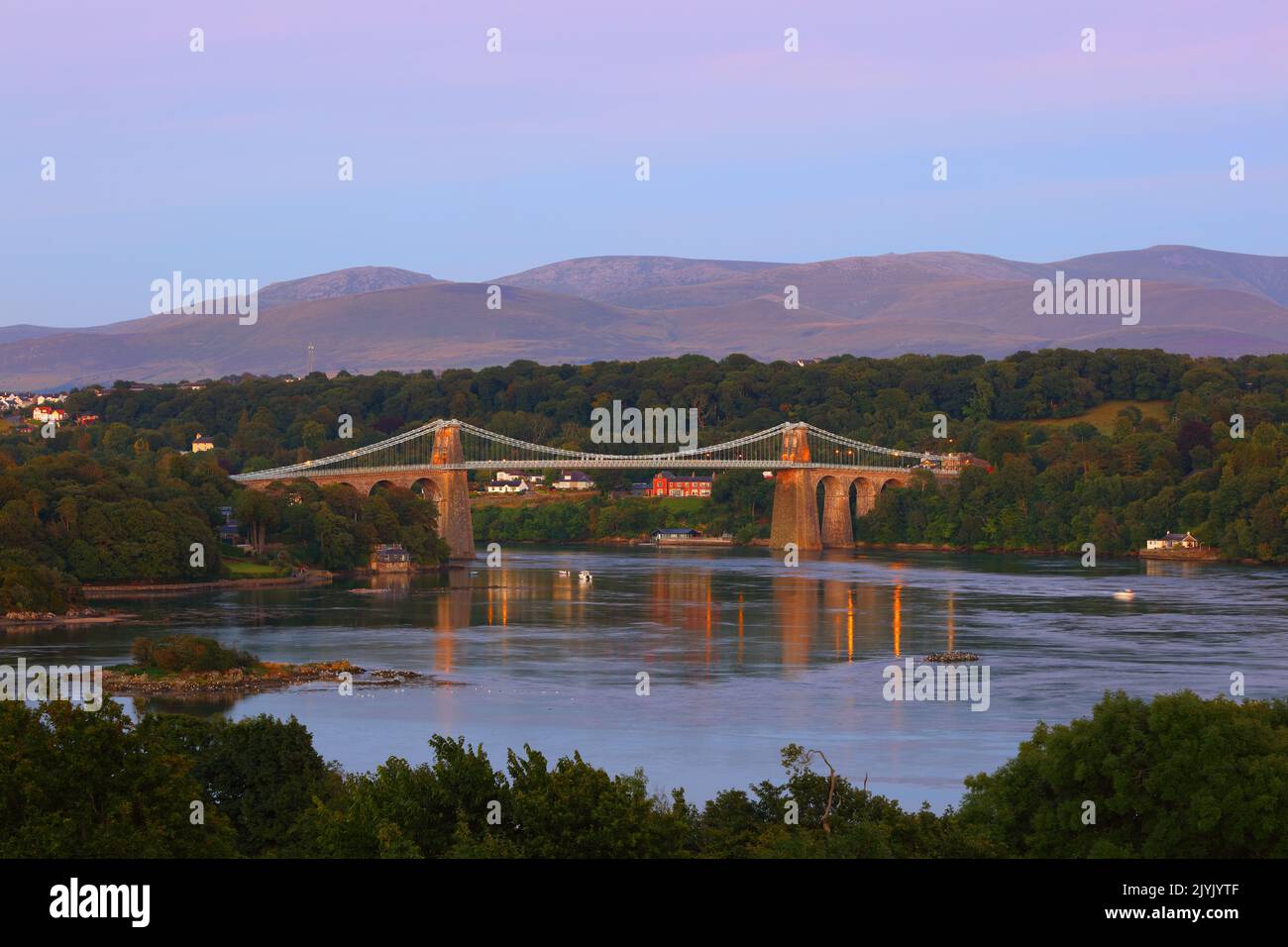 The Menai Suspension Bridge at Twilight with Snowdonia Mountains in the ...