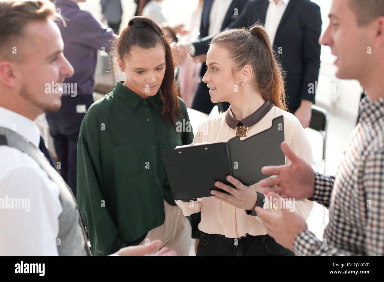 Young employees talking hi-res stock photography and images - Alamy