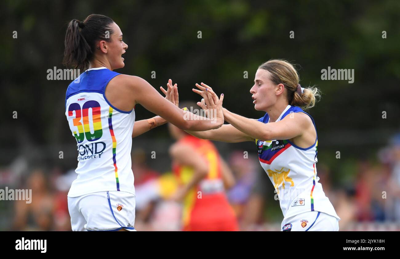 Greta Bodey (right) of the Lions celebrates kicking a goal with Jesse ...