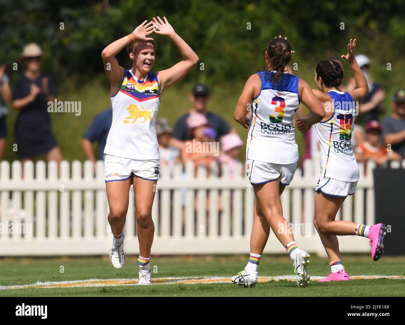 Dakota Davidson (left) of the Lions celebrates kicking a goal with team ...