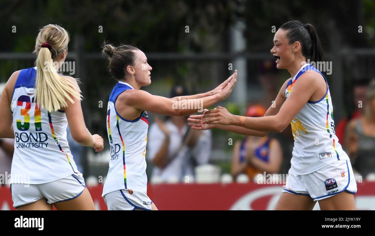Jesse Wardlaw (right) of the Lions celebrates kicking a goal with team ...
