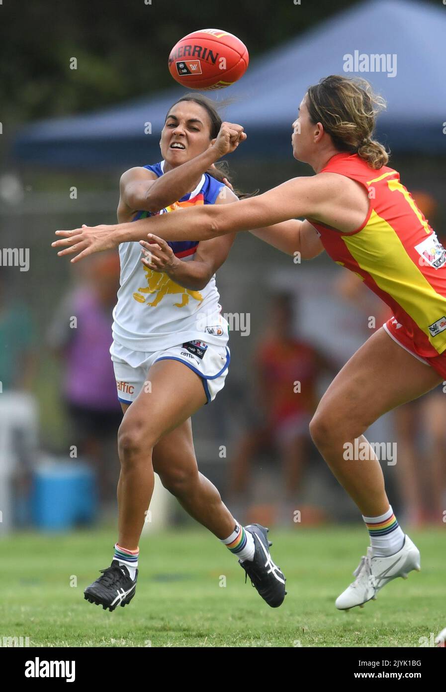Courtney Hodder (left) of the Lions handballs during the Round 2 AFLW ...