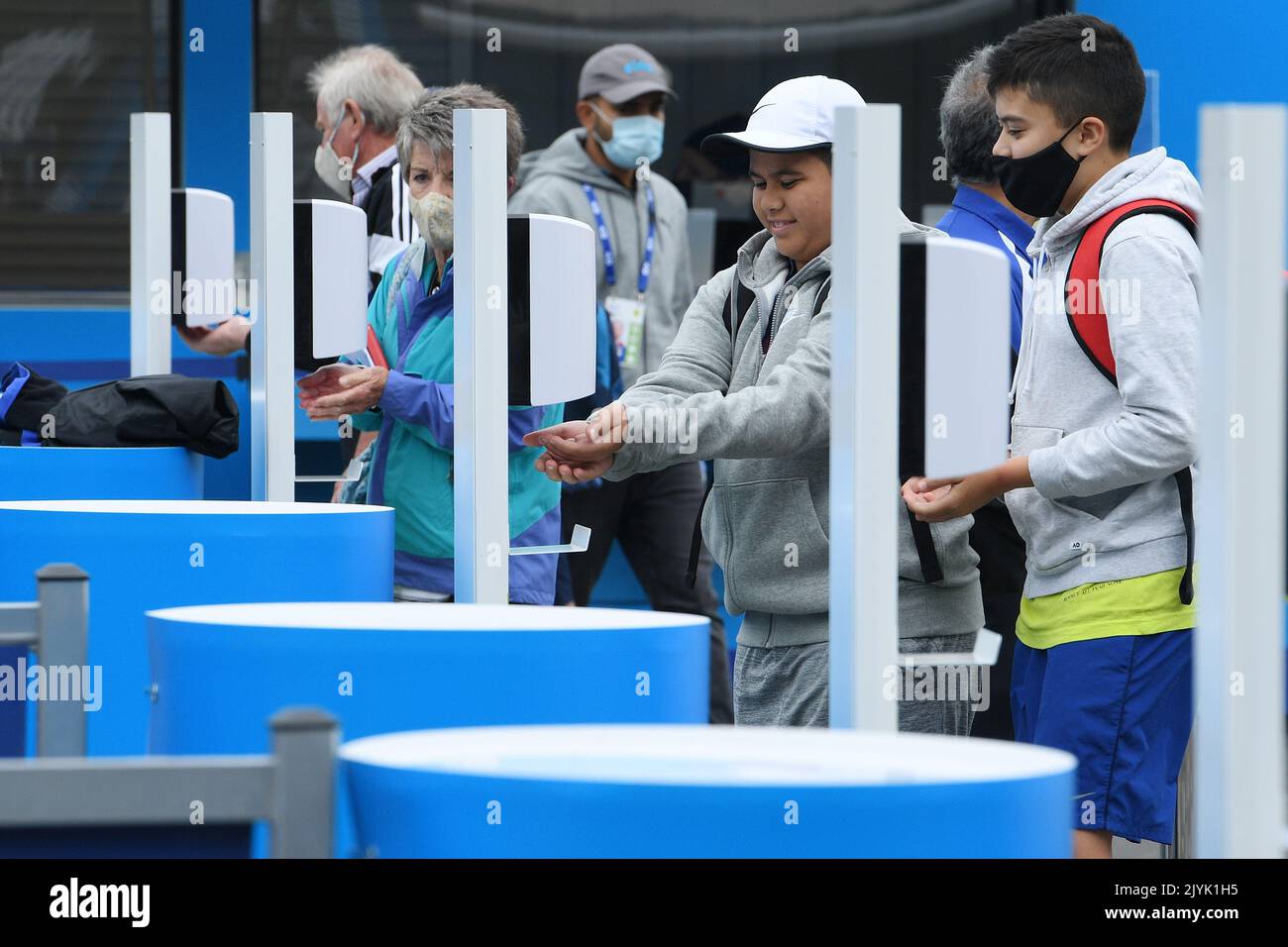 Spectators sanitise their hands as they arrive on Day 1 of the ...