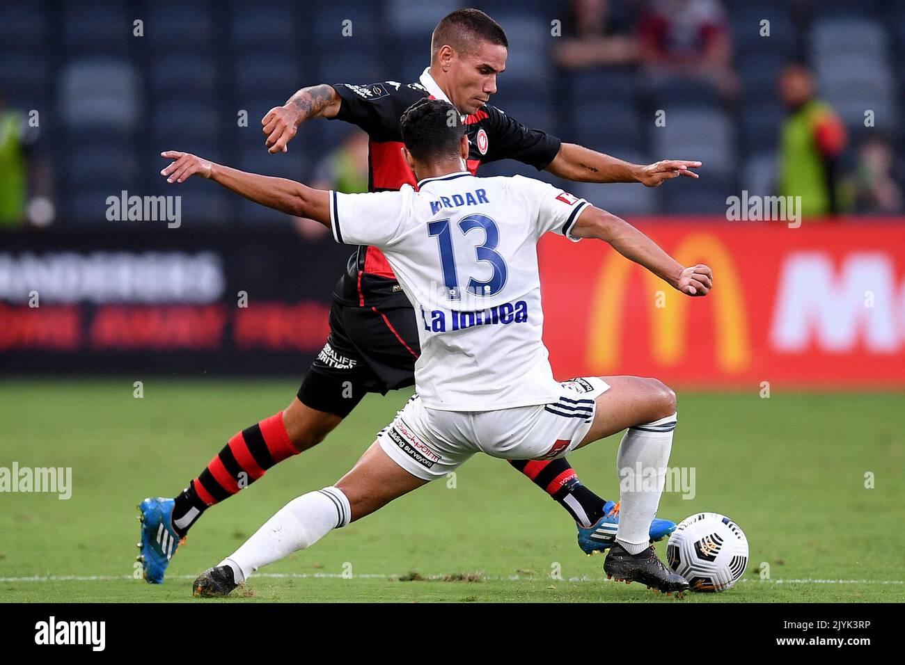 Tate Russell of the Wanderers competes for possession with Birkan ...