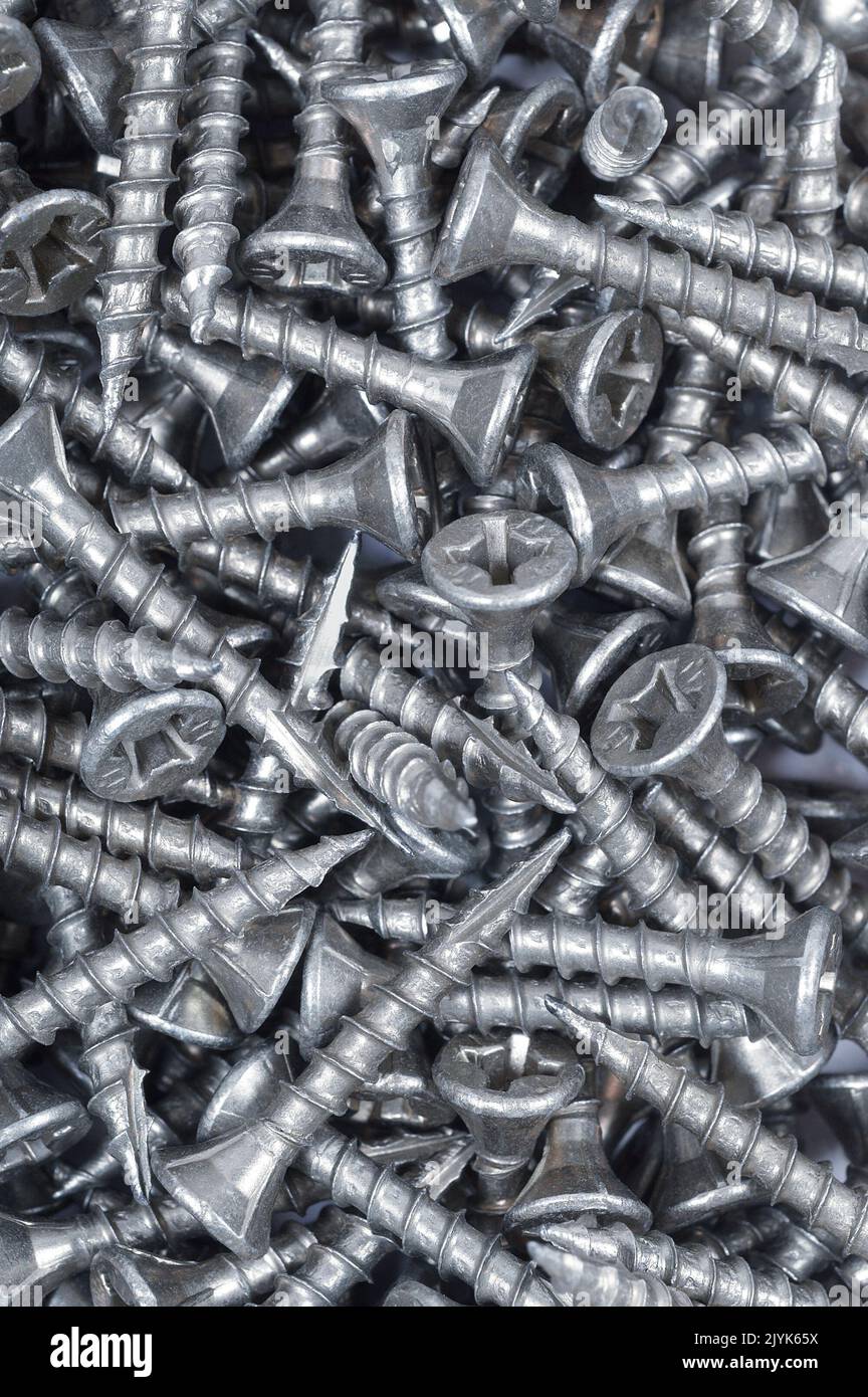 Close up of lots of metal screws full frame background Stock Photo - Alamy