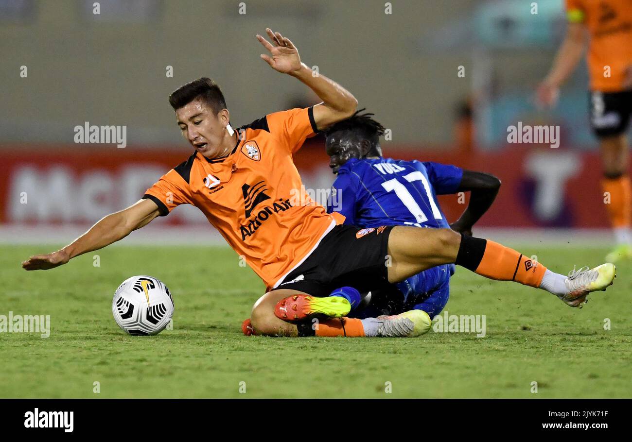 Rahmat Akbari (left) of the Roar is tackled by Valentino Yuel (right ...