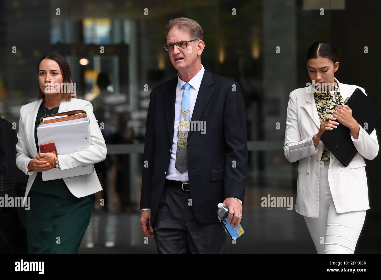 Keith Benjamin Greenland (centre) is seen leaving the Brisbane District ...