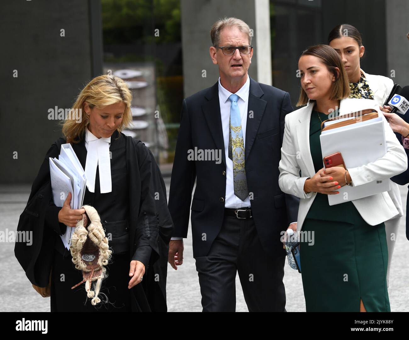 Keith Benjamin Greenland (centre) is seen leaving the Brisbane District ...