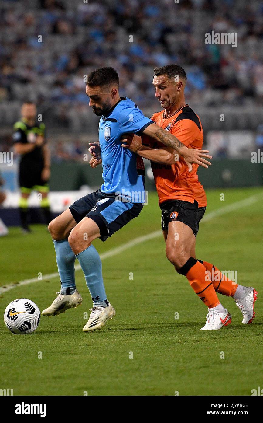 Anthony Caceres of Sydney FC competes for possession with Scott ...