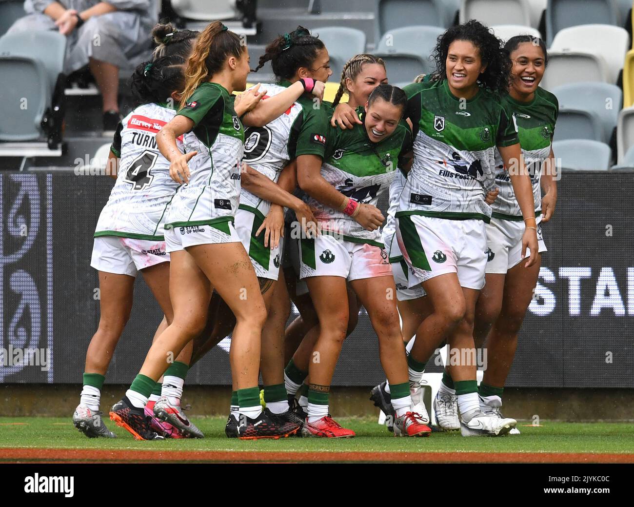 Zahara Temara (centre) of the Maori All Stars celebrates scoring a try ...