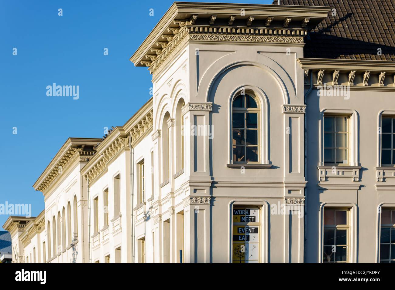 Late sun on the exterior of a white, italian style department store ...