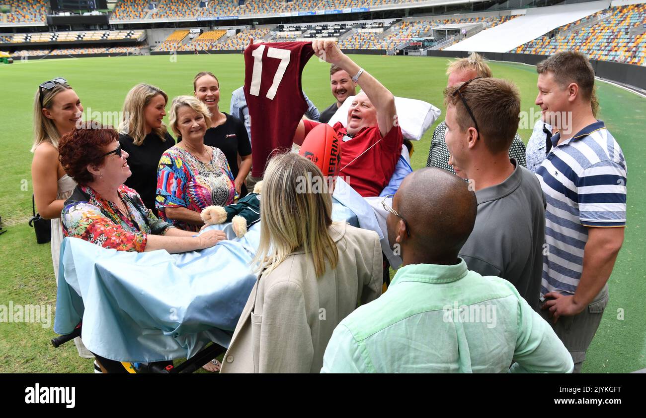 Former Queensland AFL Grand Final hero Ross Whyte (centre), who has ...