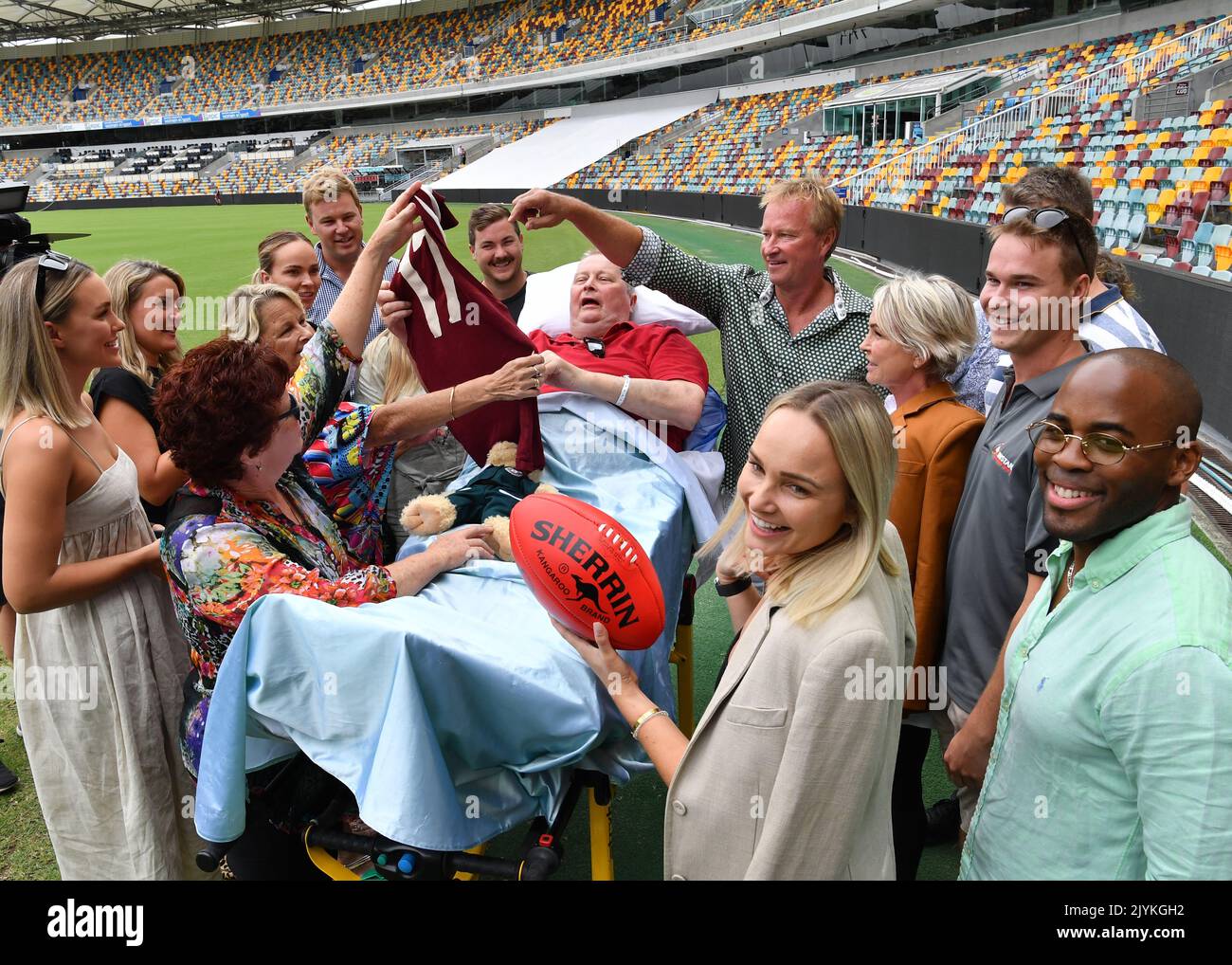 Former Queensland AFL Grand Final hero Ross Whyte (centre), who has ...