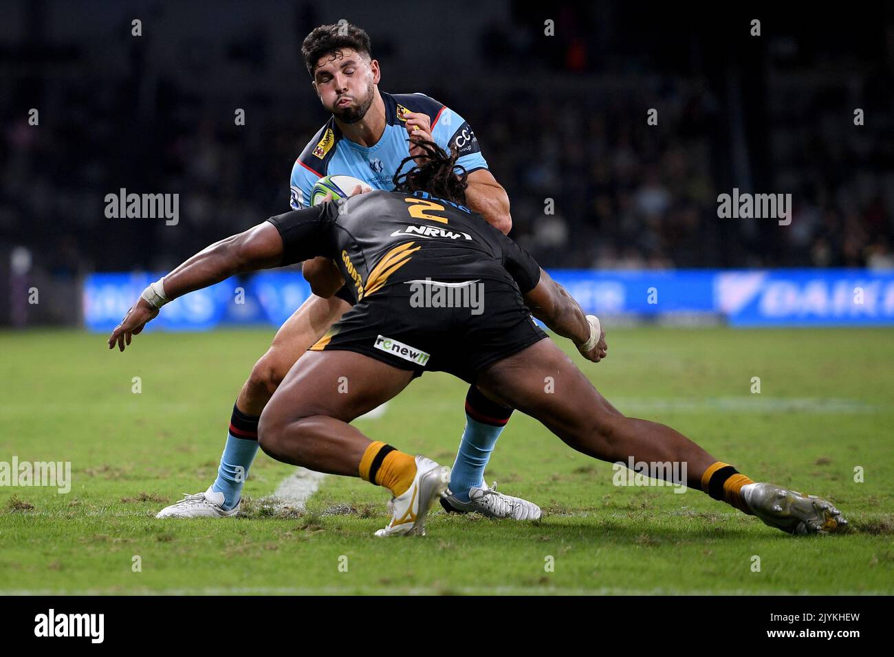 Tristan Reilly of the Waratahs is tackled by Feleti Kaitu’u of Western ...