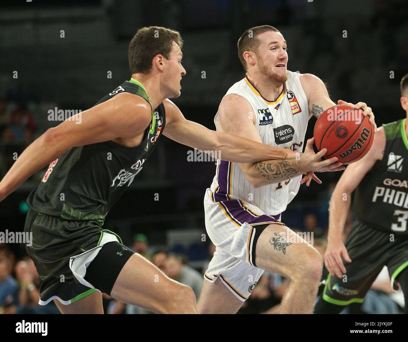 Tom Vodanovich of Sydney is fouled by Yanni Wetzell of the Phoenix ...