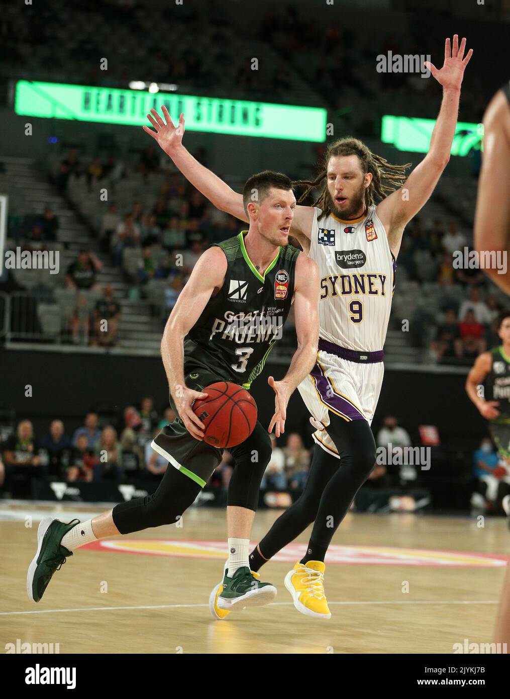 Cameron Gliddon of the Phoenix (left) under pressure from Craig Moller ...