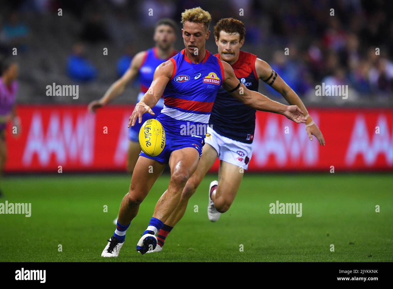 Mitch Wallis (centre) of Western Bulldogs kicks the footy during the ...