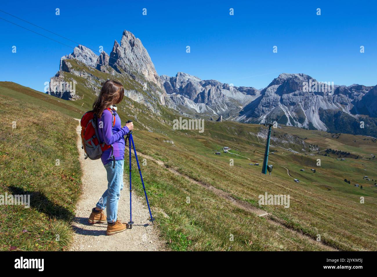 girl hiker at the mountains Dolomites and views of the valley, Italy ...