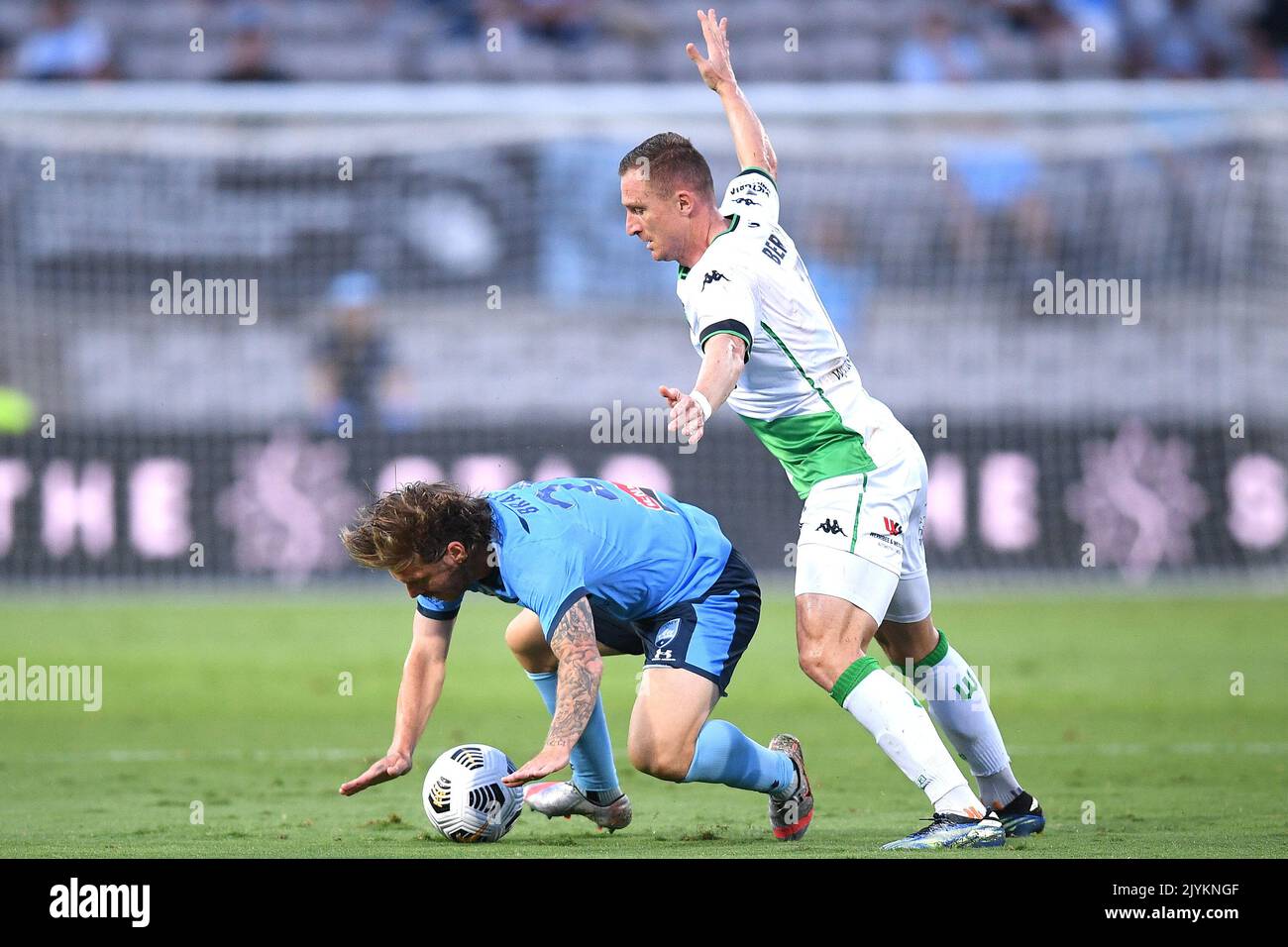 Luke Brattan of Sydney FC is tackled by Besart Berisha of Western ...