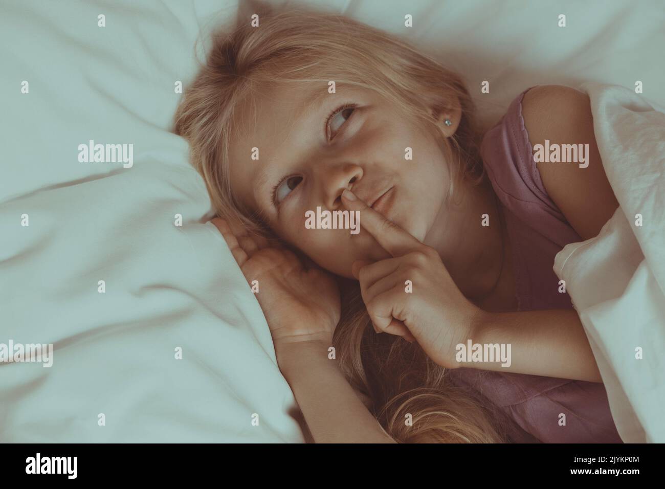 little girl lying in bed Stock Photo - Alamy