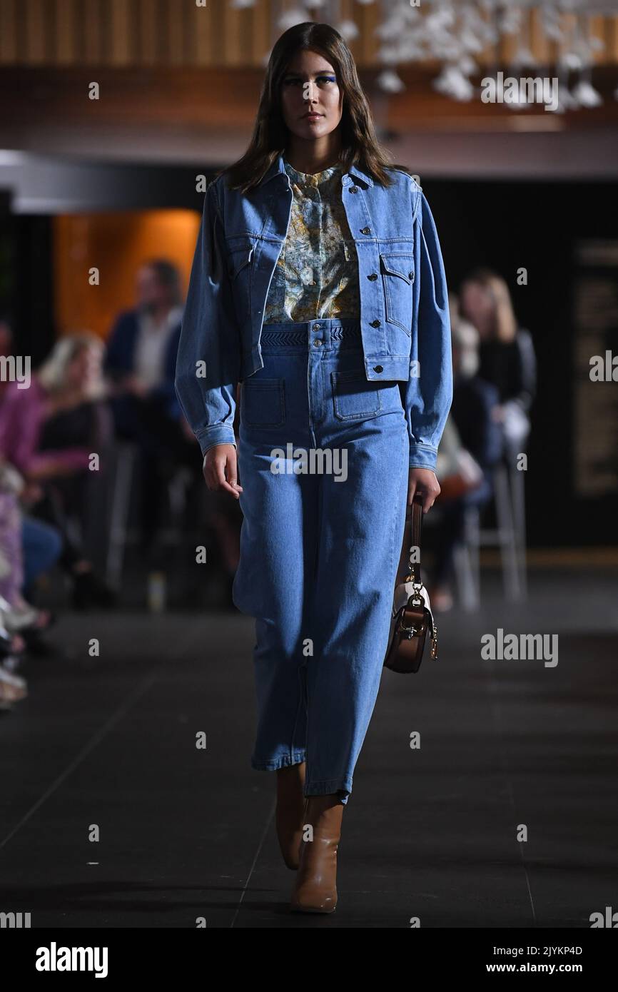 A model walks the runway wearing a design by Ginger & Smart during the ...