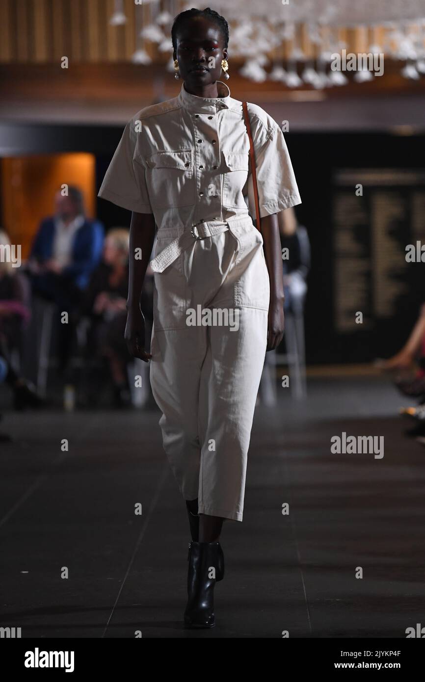 A model walks the runway wearing a design by Alexander McQueen during ...